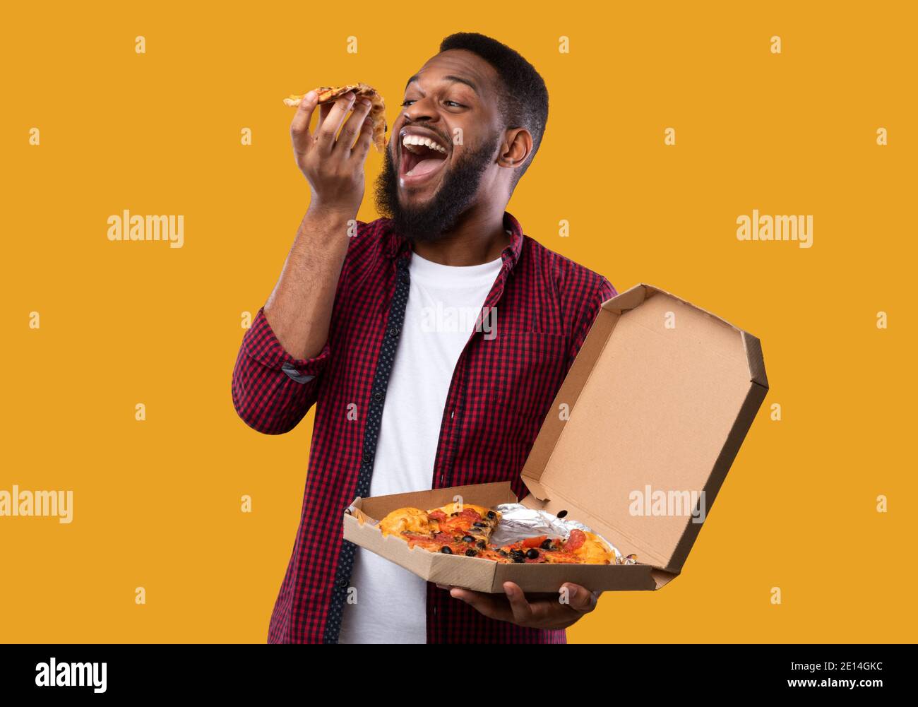 Black Man Eating Pizza Standing Holding Pizzeria Box, Yellow Background ...