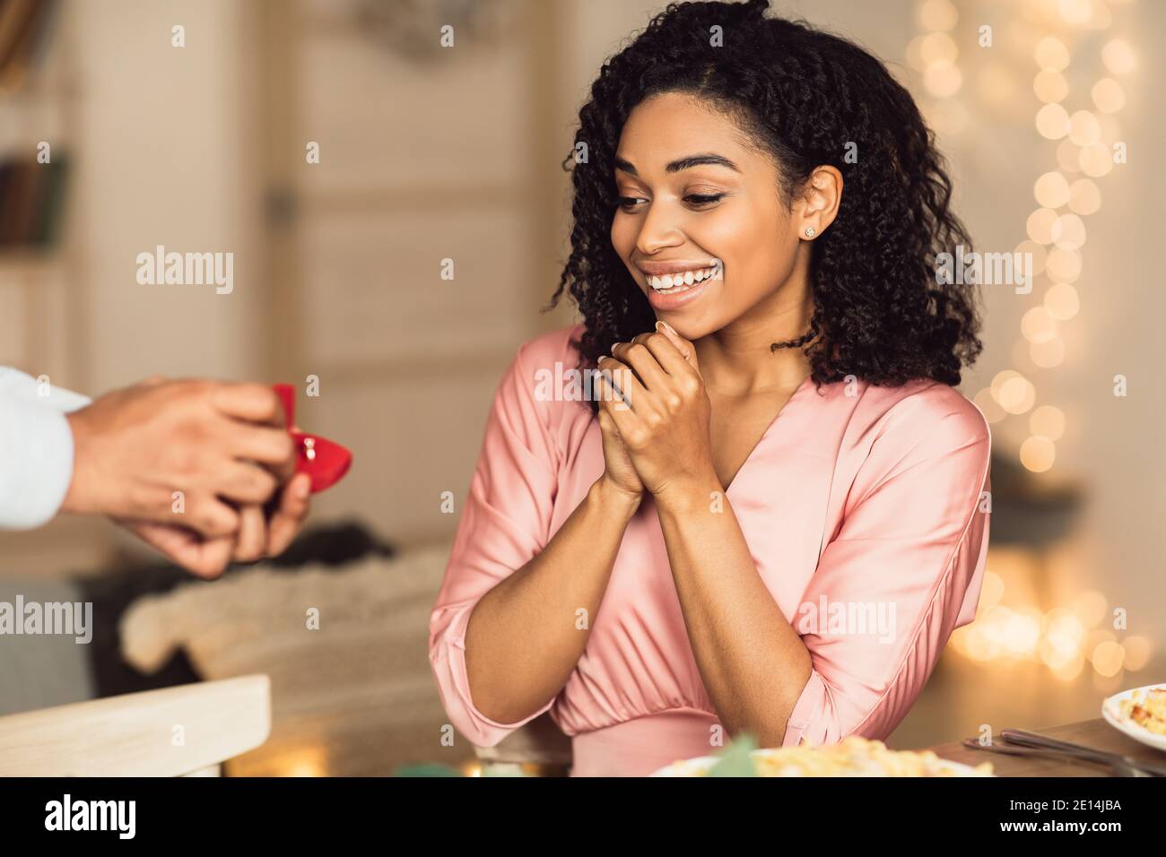 Young black man making proposal with ring to his woman Stock Photo - Alamy