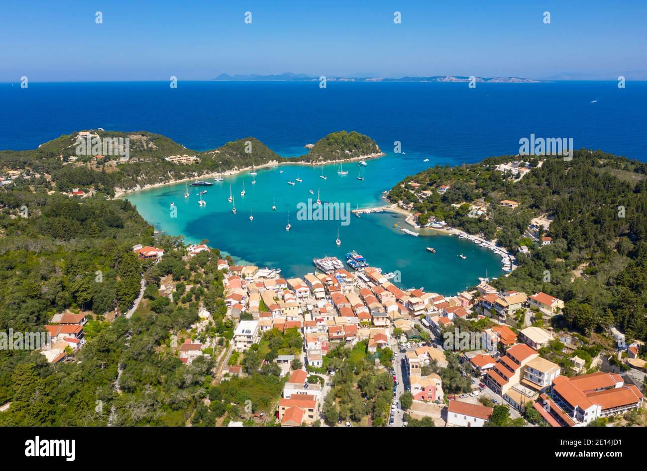 Aerial coastal view of the village of Lakka on the north coast of Paxos ...