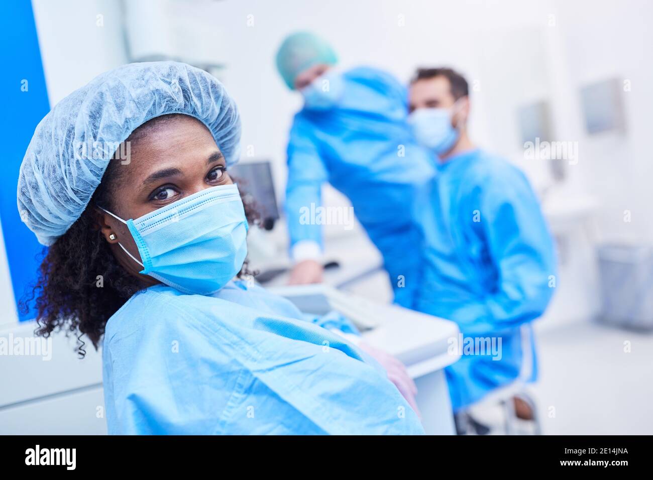 African woman as a researcher in the biotech laboratory with face mask ...