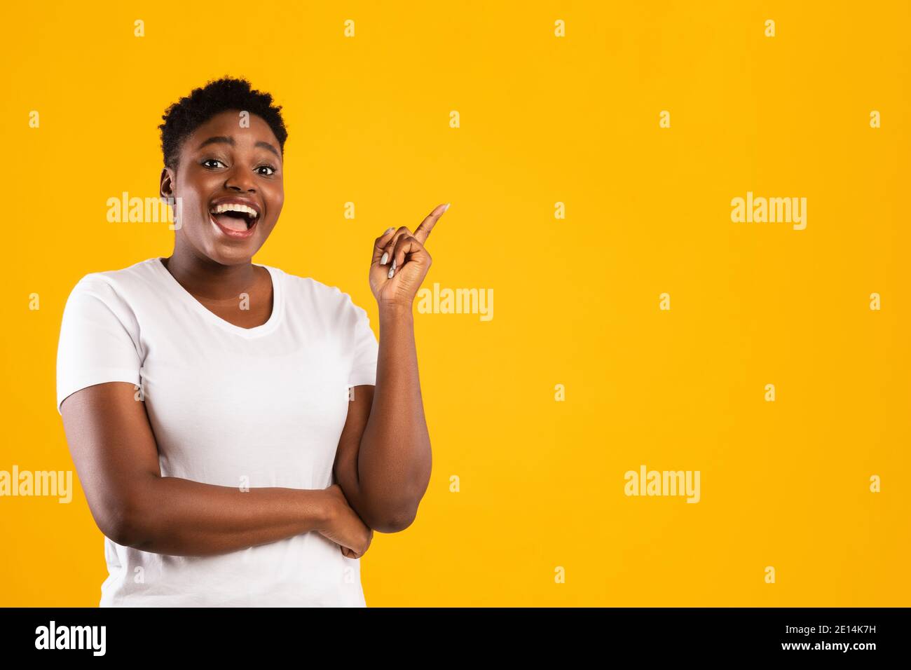 Cheerful African Woman Pointing Finger Up Having Idea, Yellow ...