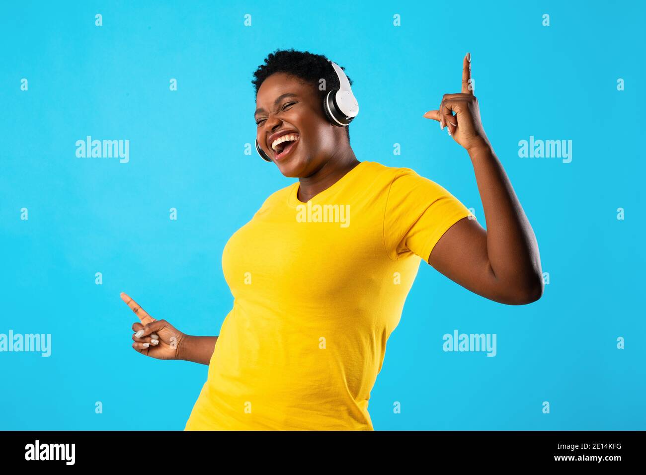 Plus-Size Black Lady Listening To Music Dancing Over Blue Background ...