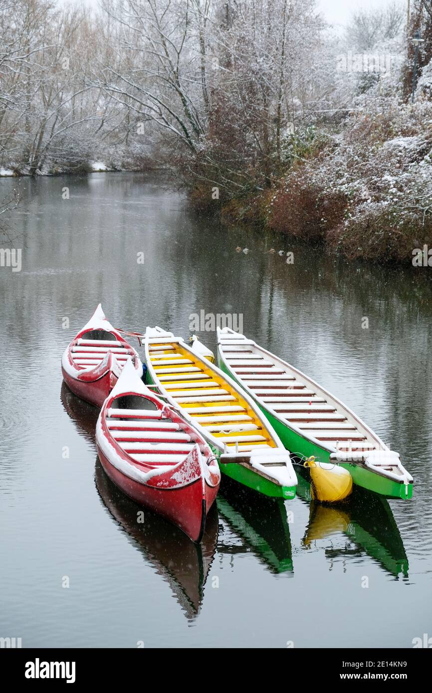 Colorful Paddle boats in hibernation on the river with snowy background ...