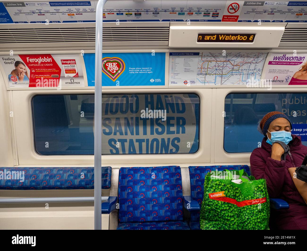 PAssengers wear a mask on a London undeground tube train Stock Photo ...