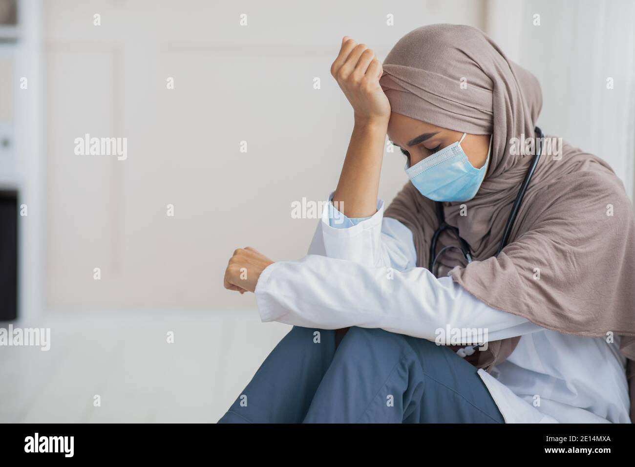 Sad woman doctor in hijab having difficult day at clinic Stock Photo ...
