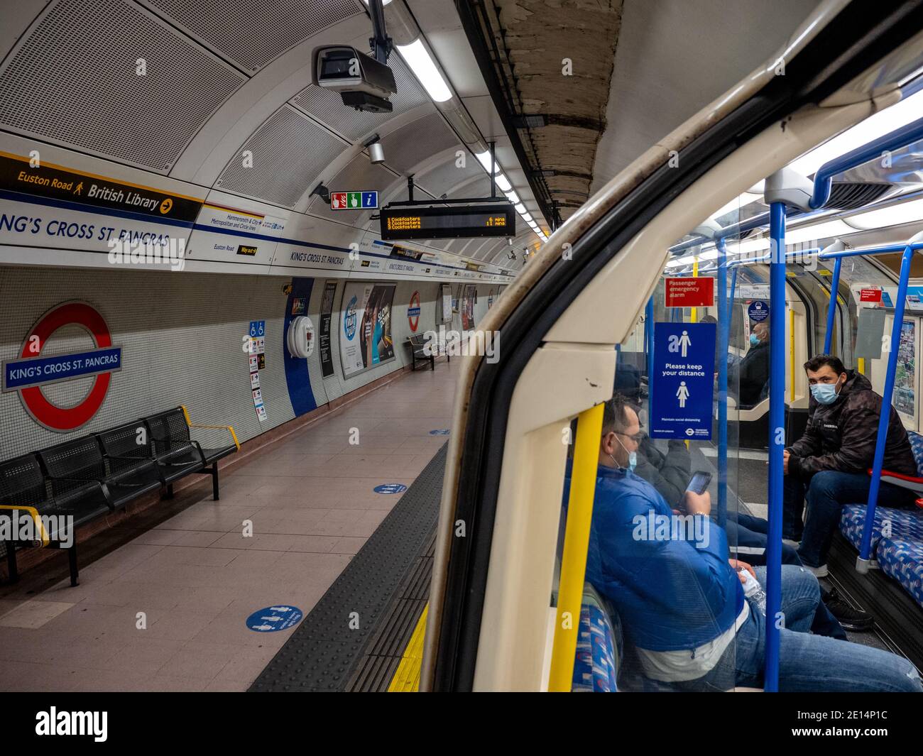 PAssengers wear a mask on a London undeground tube train Stock Photo ...