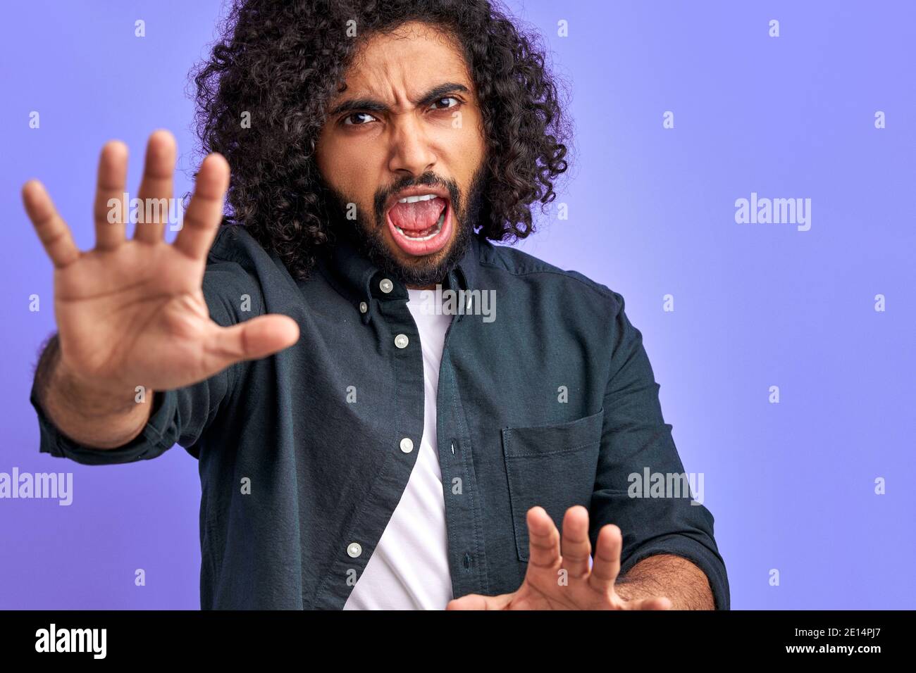 man raising hand up in calm down, wait sec or stop gesture, panick ...