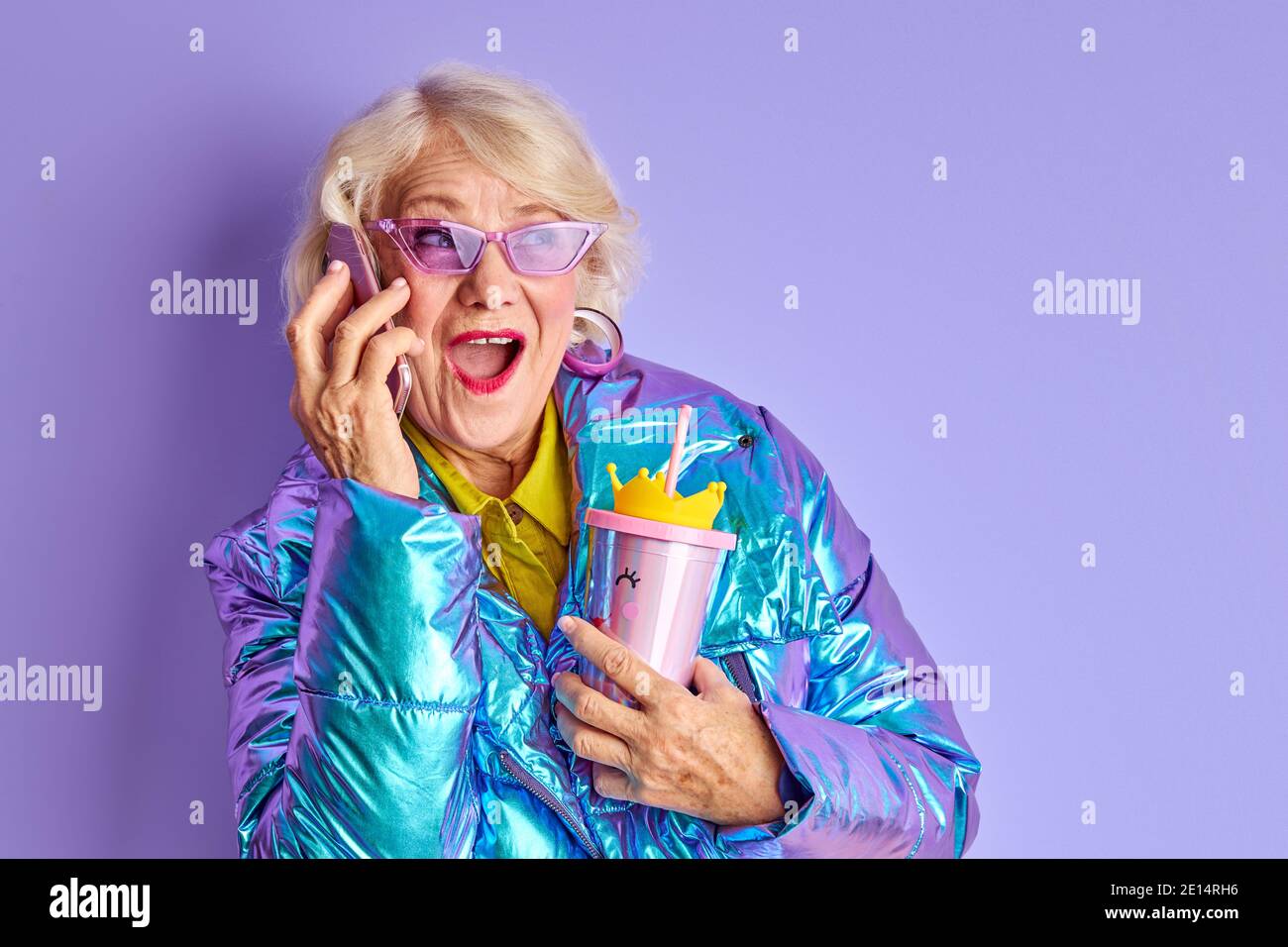 female 60 years old have talk on phone with someone, laugh, holding ...