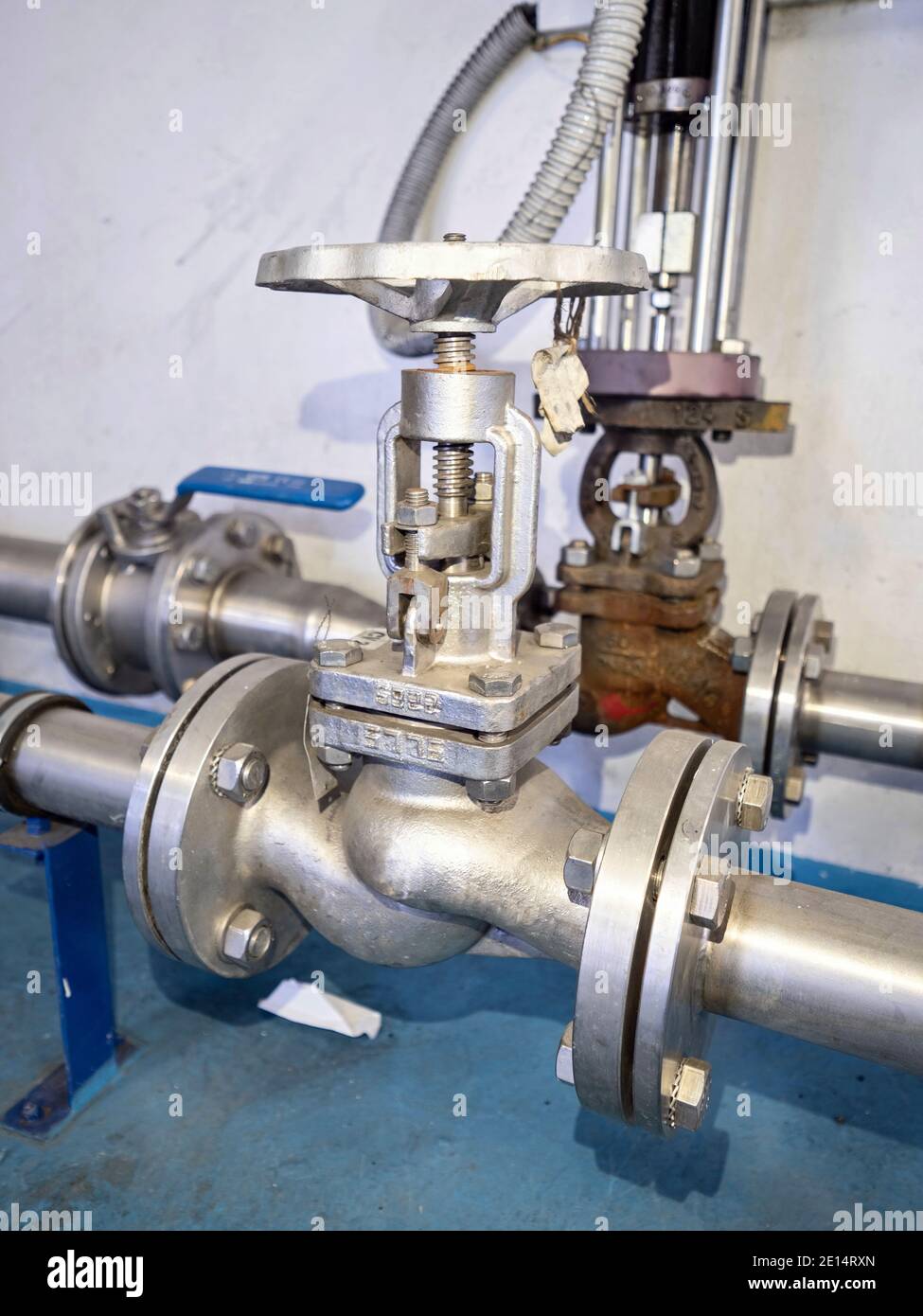 Stainless stopcock valve on stainless gas pipeline branch. Cables to ...