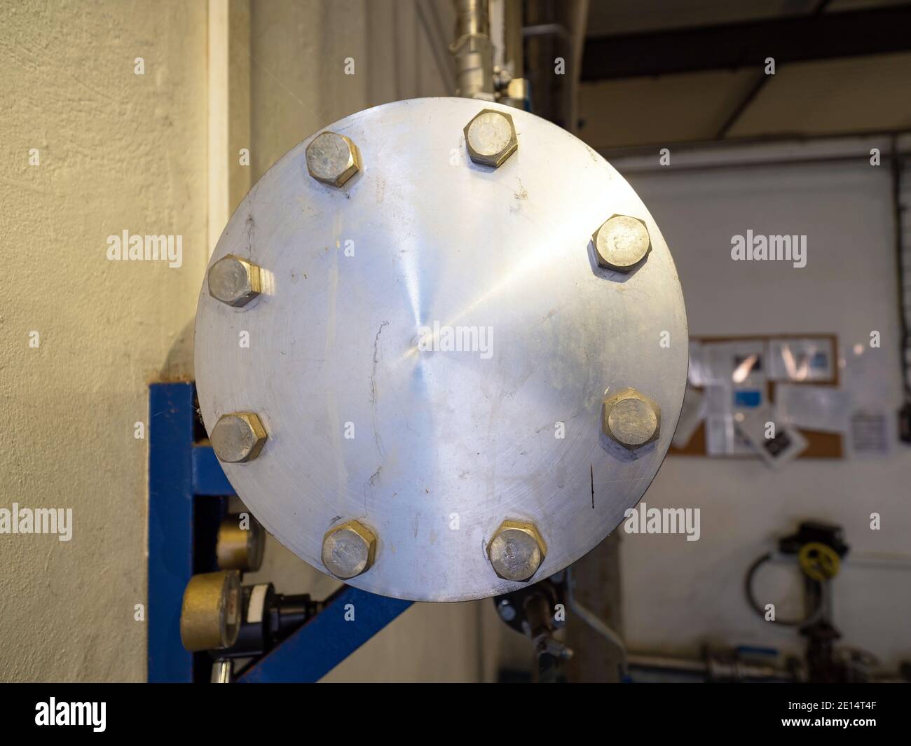 Chrome steel pipeline end cap screwed with large screws. Power plant ...