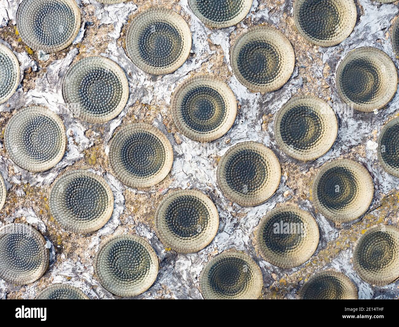 Round glass brick wall. Glassy windows with dotted surface texture ...
