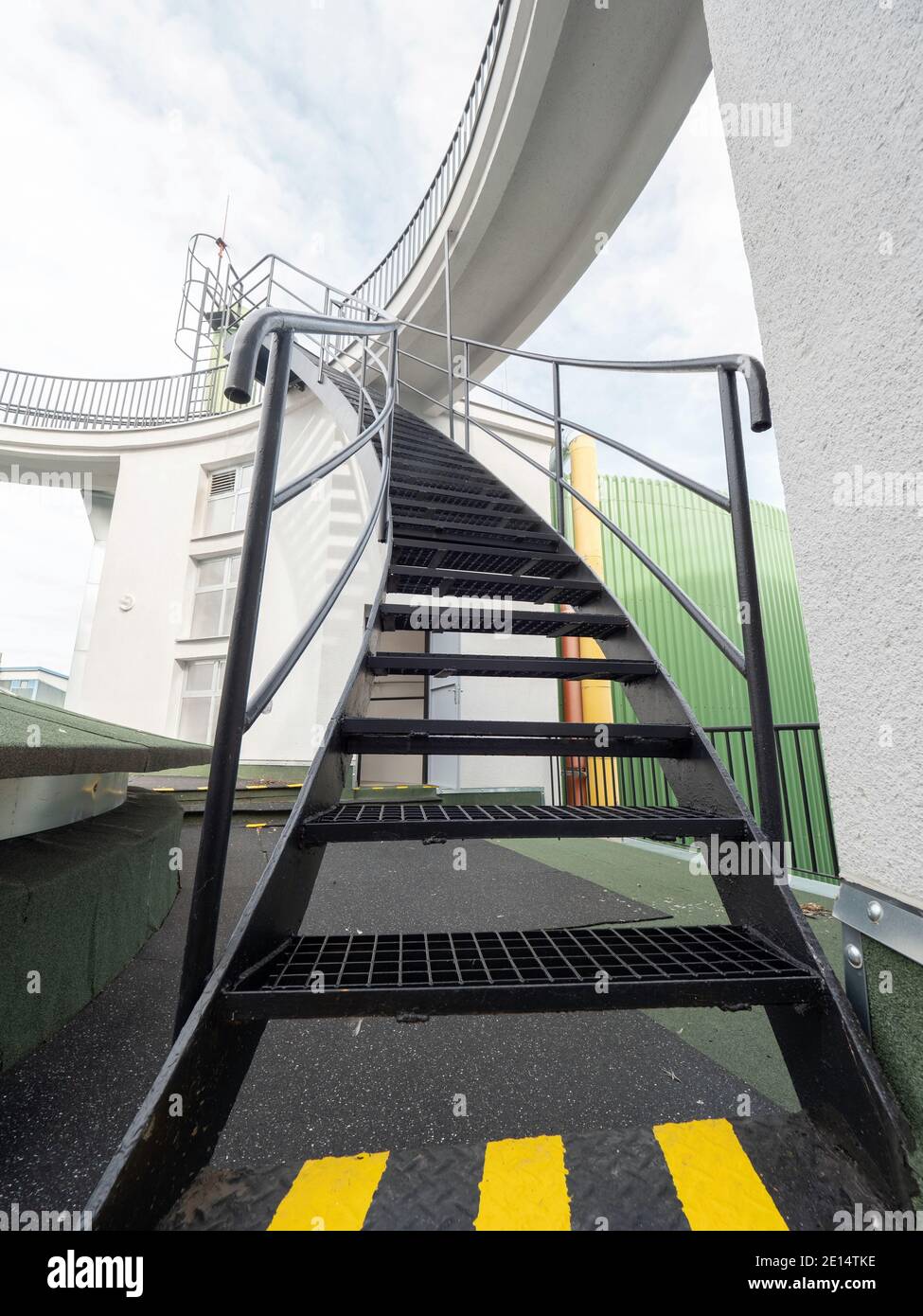 Outdoor stairs of an escape exit in a factory. Yellow markings on the ...