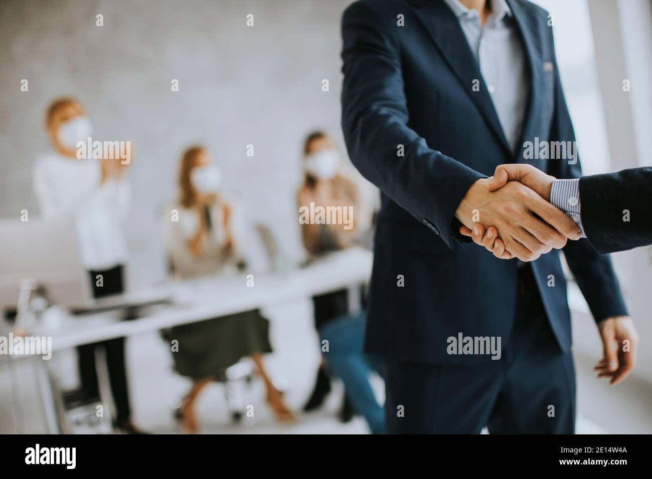 Closeup of the young business men handshaking in the office Stock Photo ...