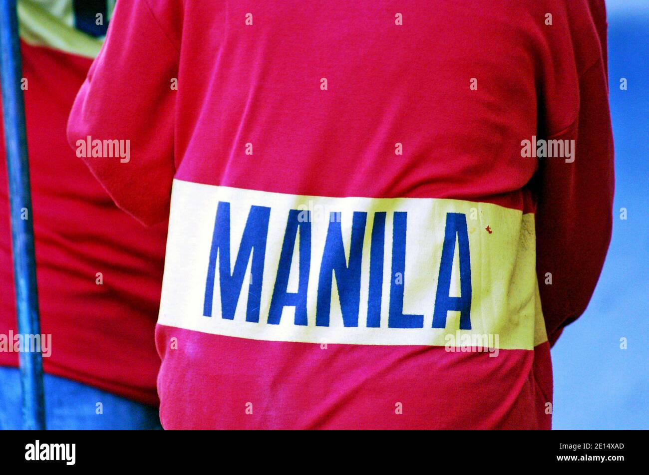A street cleaner in Manila, Philippines is identified by the red ...