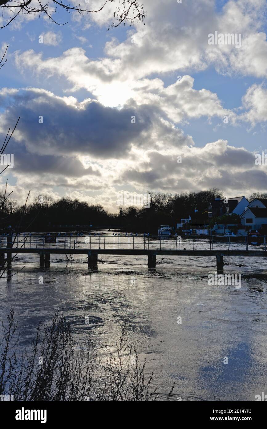 Dramatic and moody winter cloud formation reflected in the River Thames ...