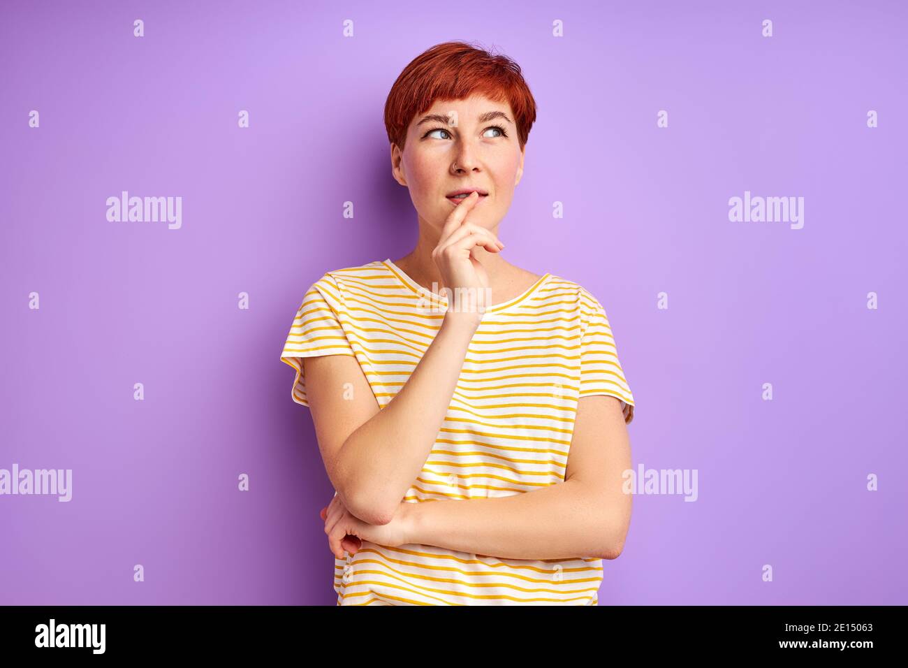 thoughtful female with red hair stand thinking looking up, people and ...
