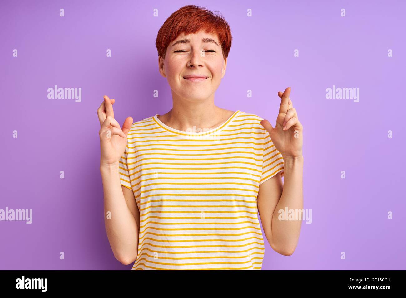 emotional female keeping fingers together, good luck. isolated over ...