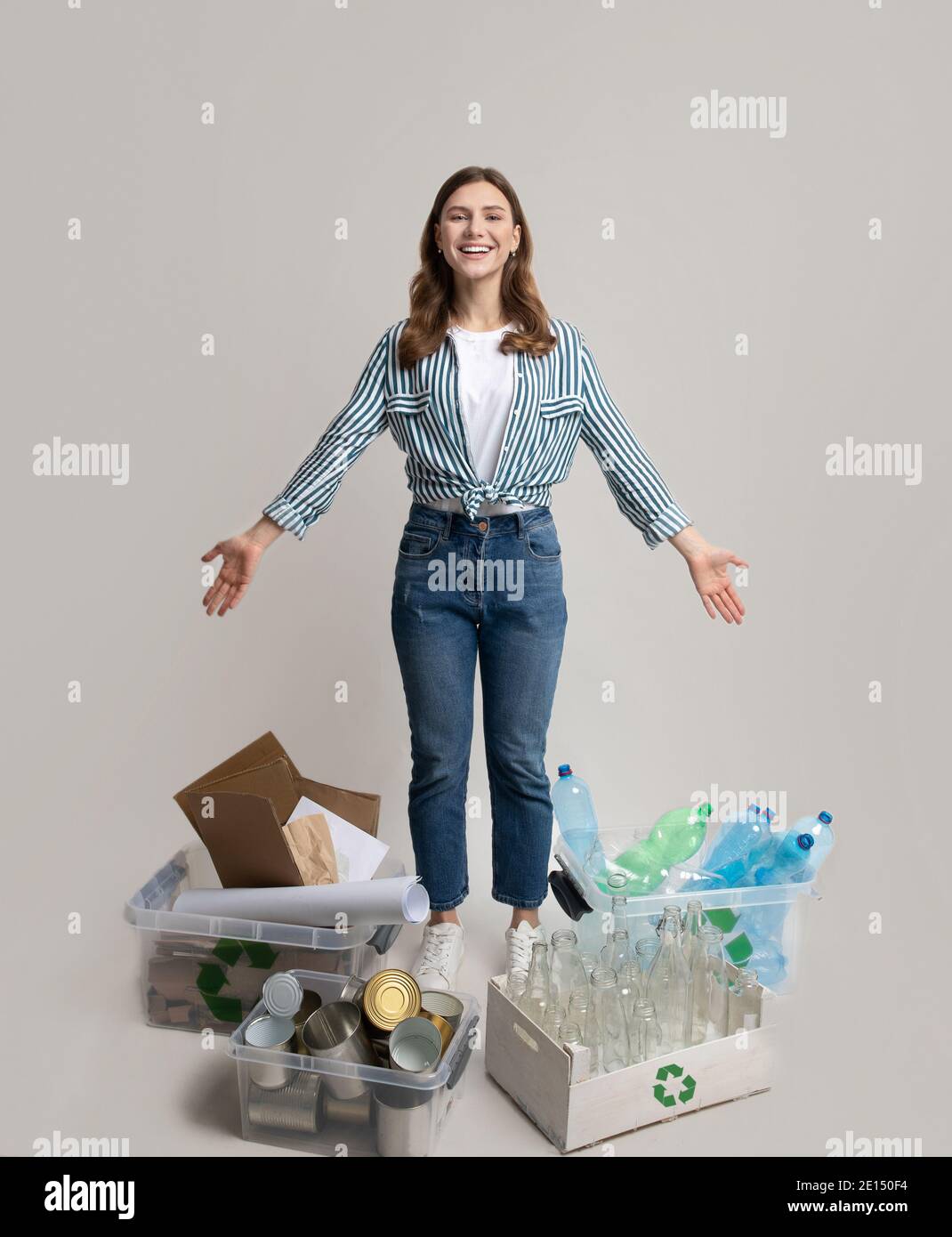 Waste Sorting. Happy woman standing among different kind of sorted ...