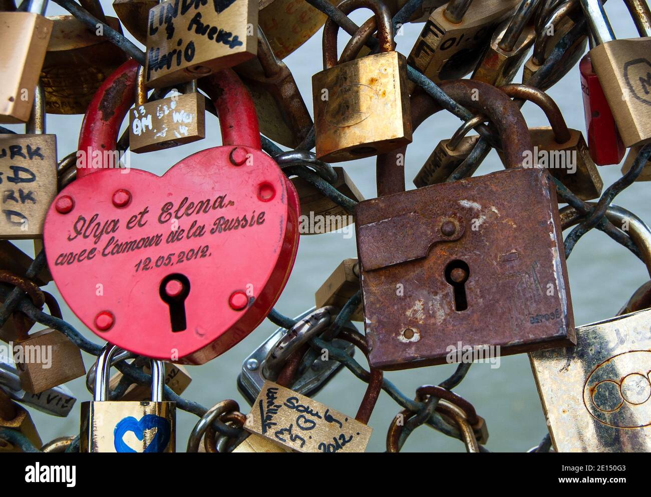 Red heart shape padlock and old rusty padlock among other love locks ...