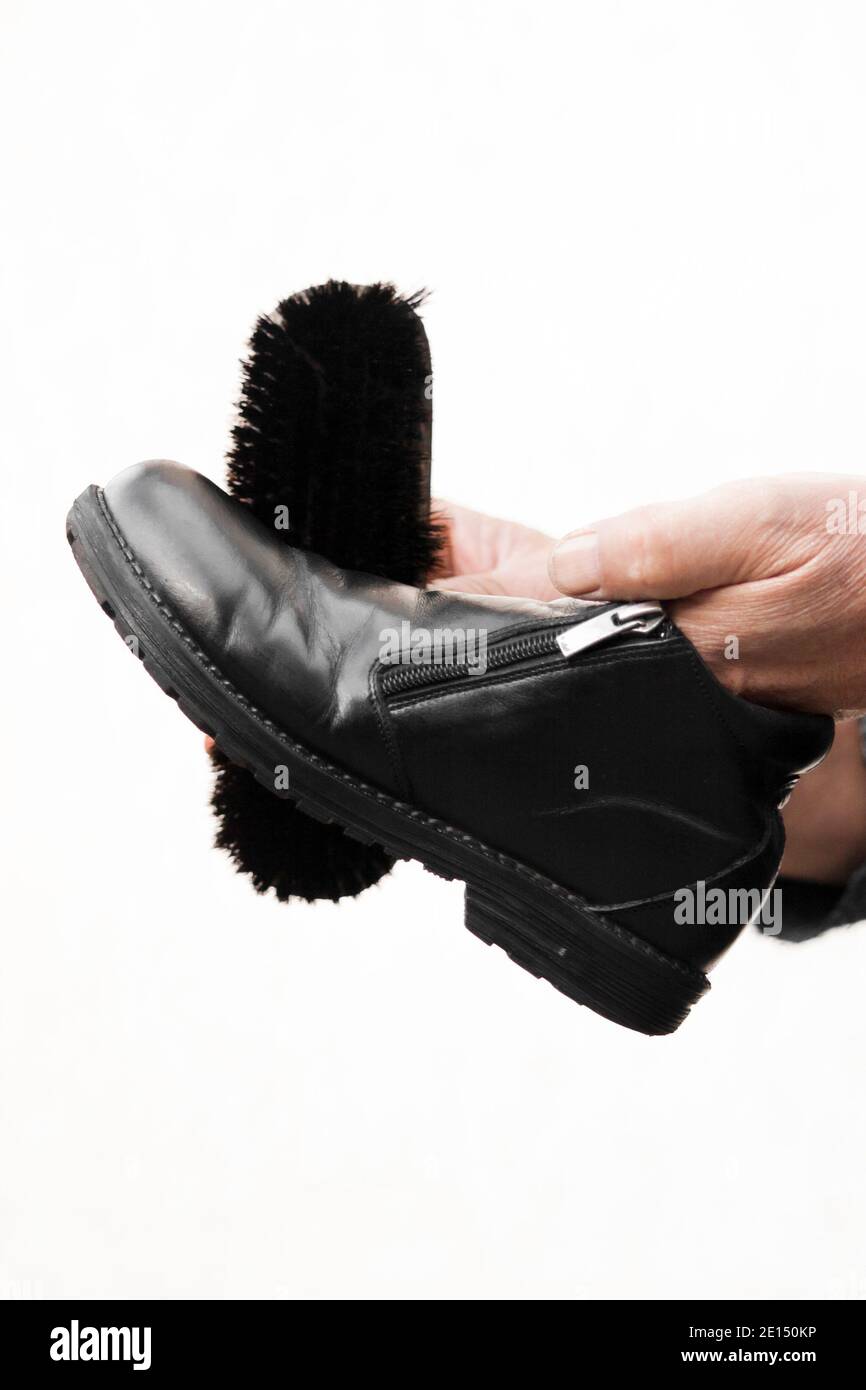 Leather shoe care. Cleaning leather shoes with black shoe cream Stock ...