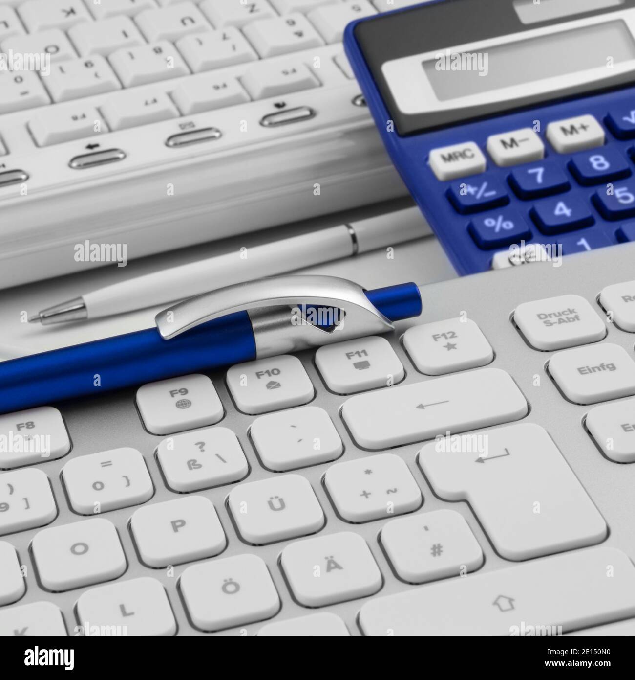 Workplace with calculator and PC two keyboards close up Stock Photo - Alamy