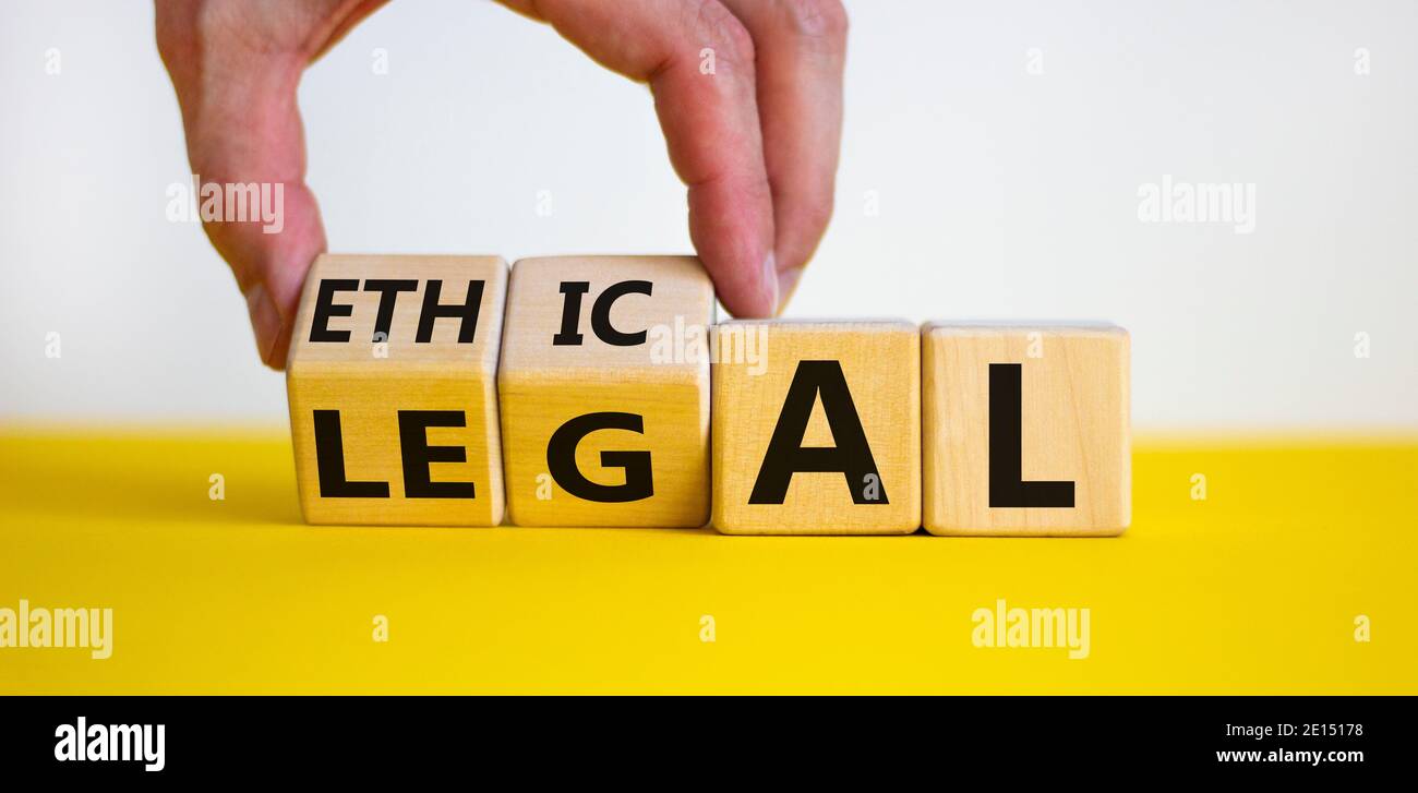 Ethical or legal symbol. Businessman hand turns wooden cubes and ...