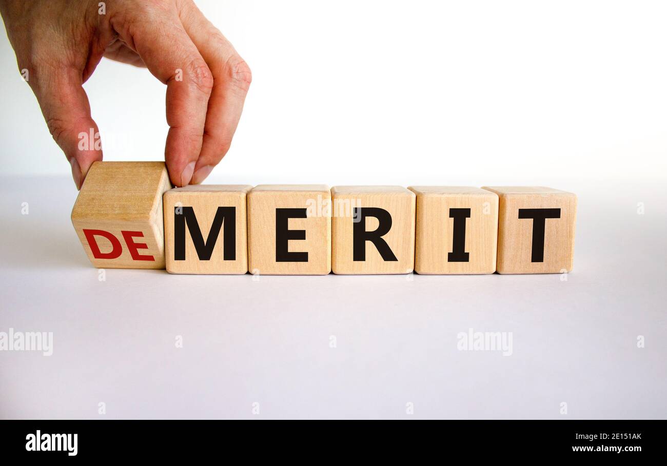 Demerit or merit symbol. Male hand flips the wooden cube and changes ...