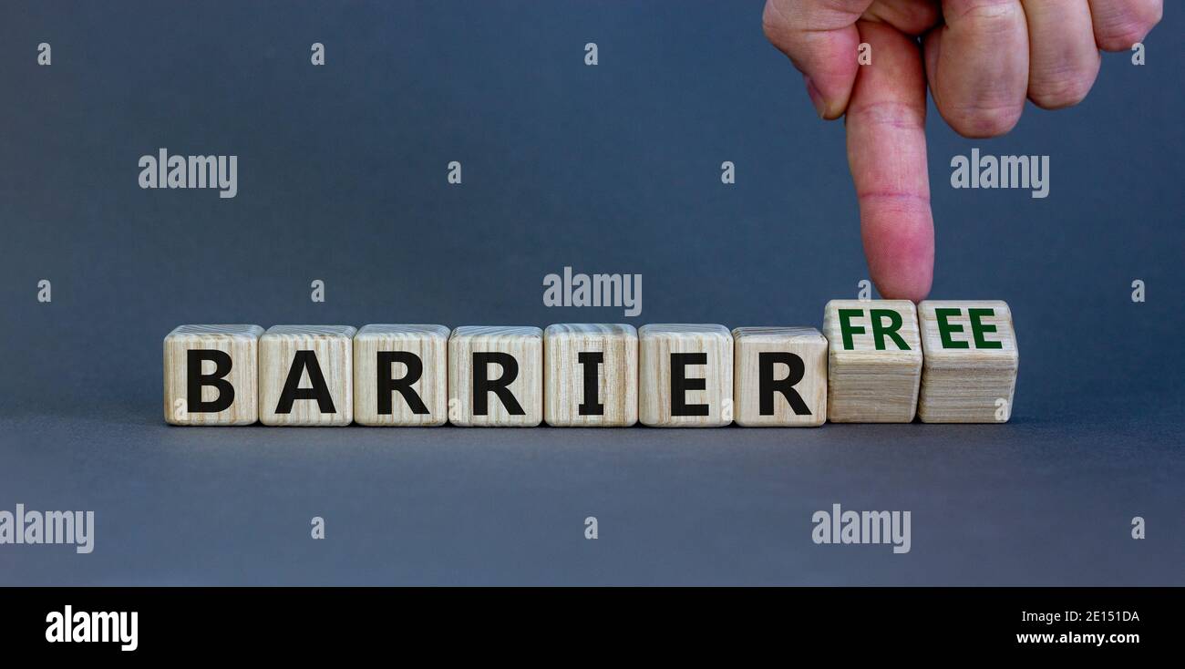 Barrier free symbol. Male hand turns wooden cubes and changes words ...