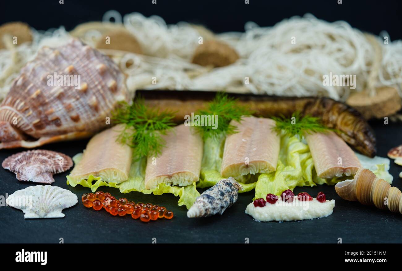 Fillet of a golden smoked eel Stock Photo - Alamy