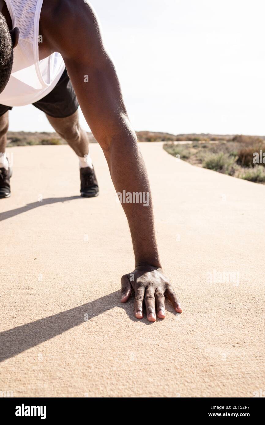 Closed shot from the arm of a young black runner doing push-ups Stock ...