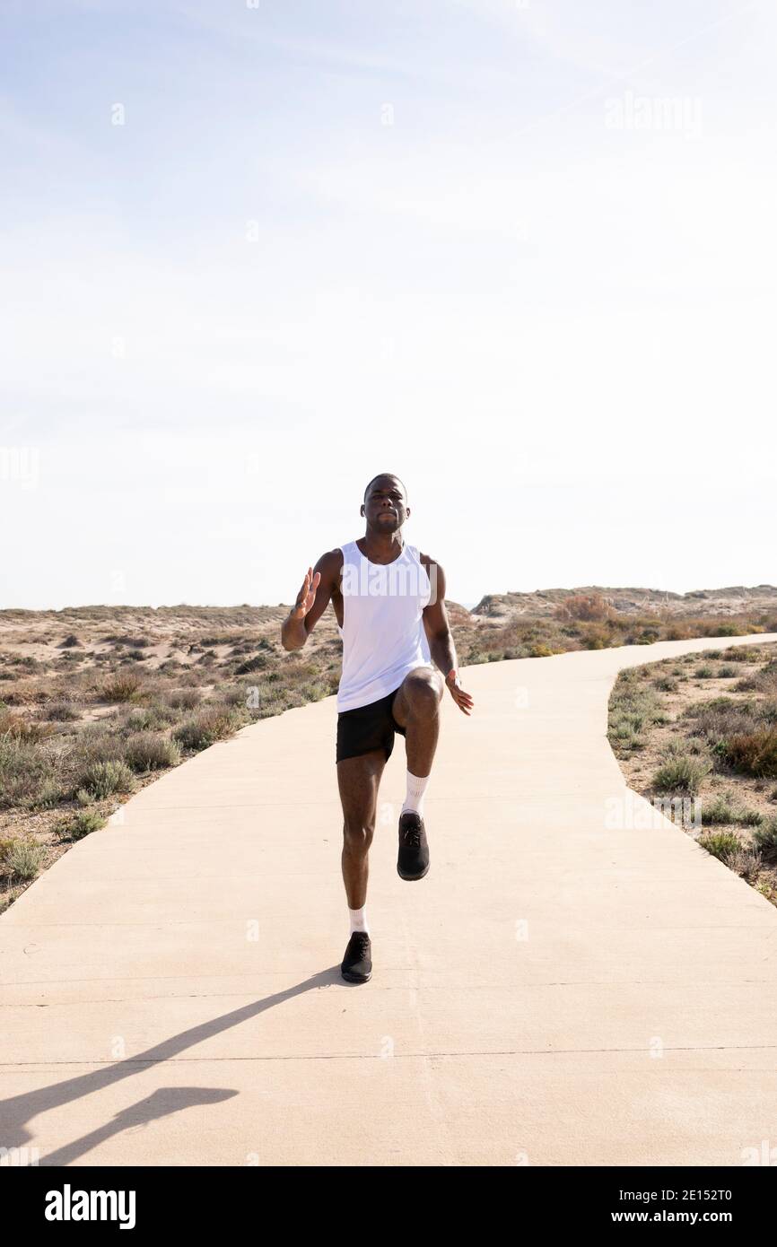 Vertical shooting of a sports trainer performing warm-ups before ...