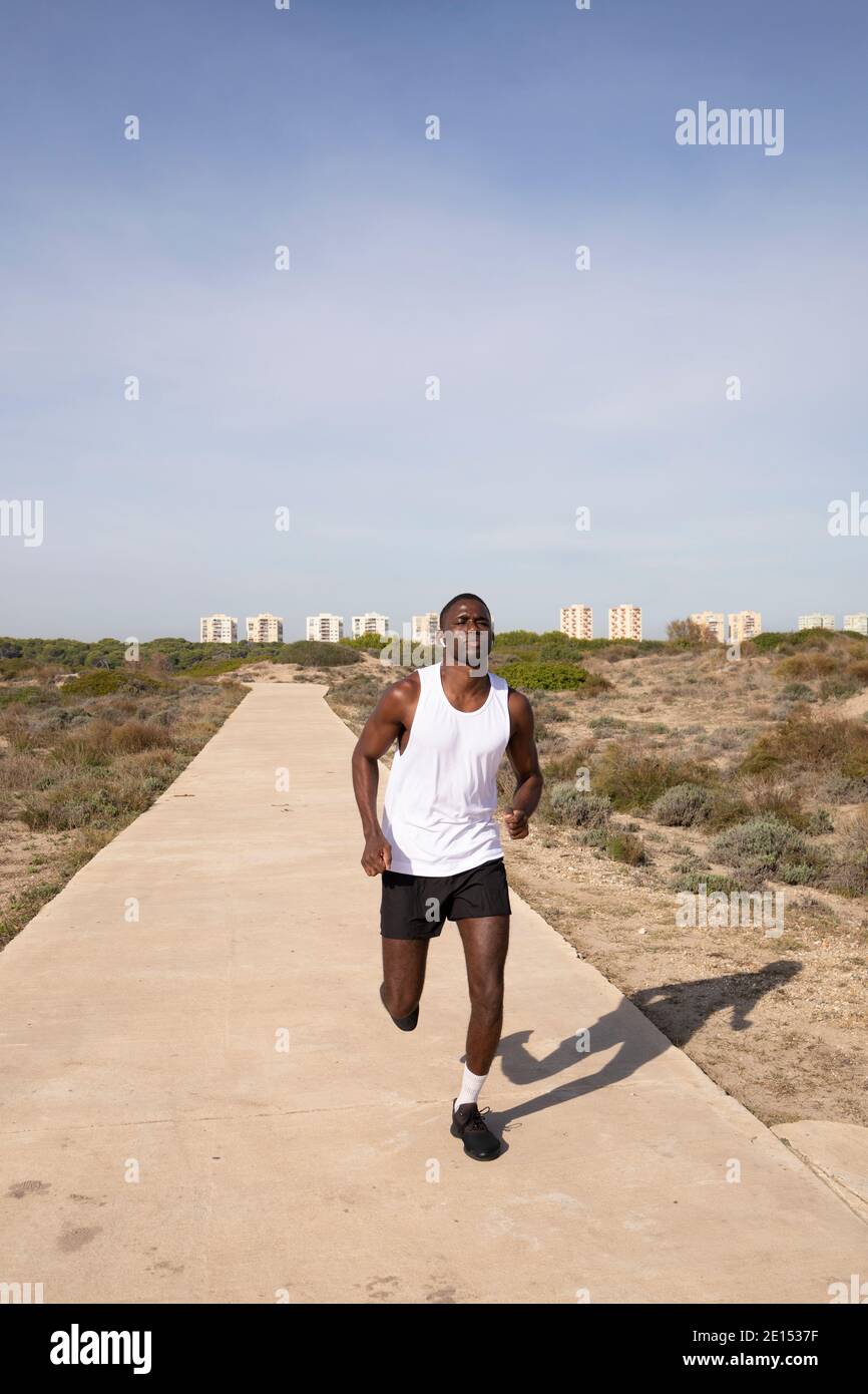 Young black sports coach running. Concept of sport Stock Photo - Alamy
