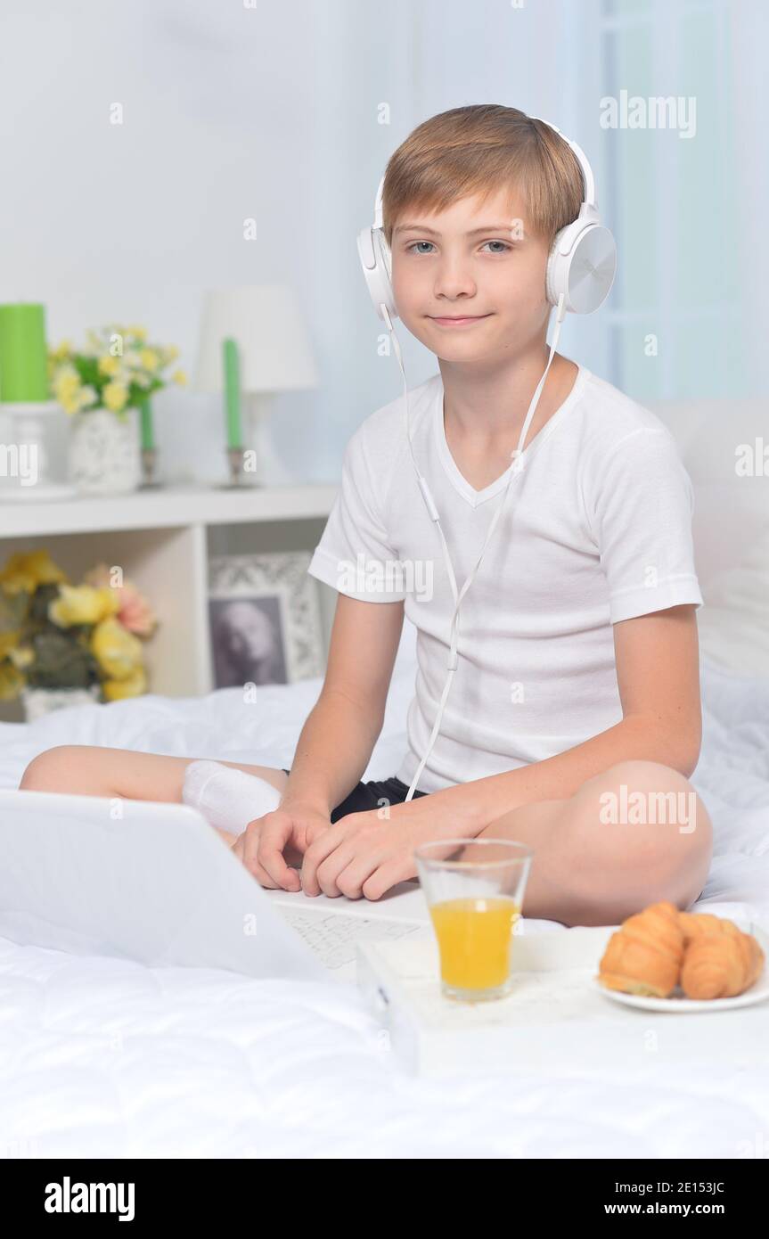 Boy listening music on computer hi-res stock photography and images - Alamy