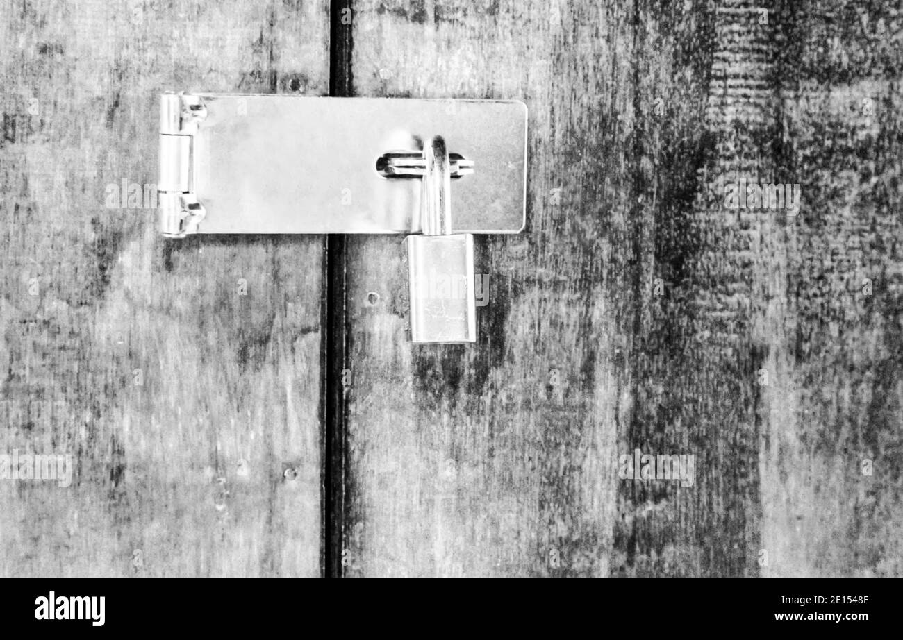 White painted wooden door padlock on a light background washed wood ...