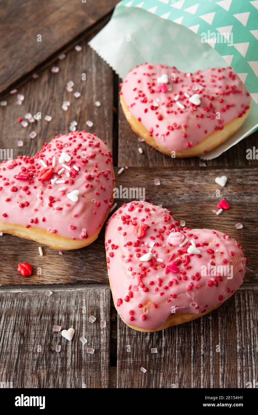 Pink Heart Donuts With Sprinkles Stock Photo - Alamy