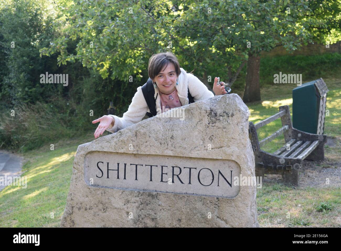 Person Standing Over Stone Sign for Shitterton, a Hamlet in Dorset ...