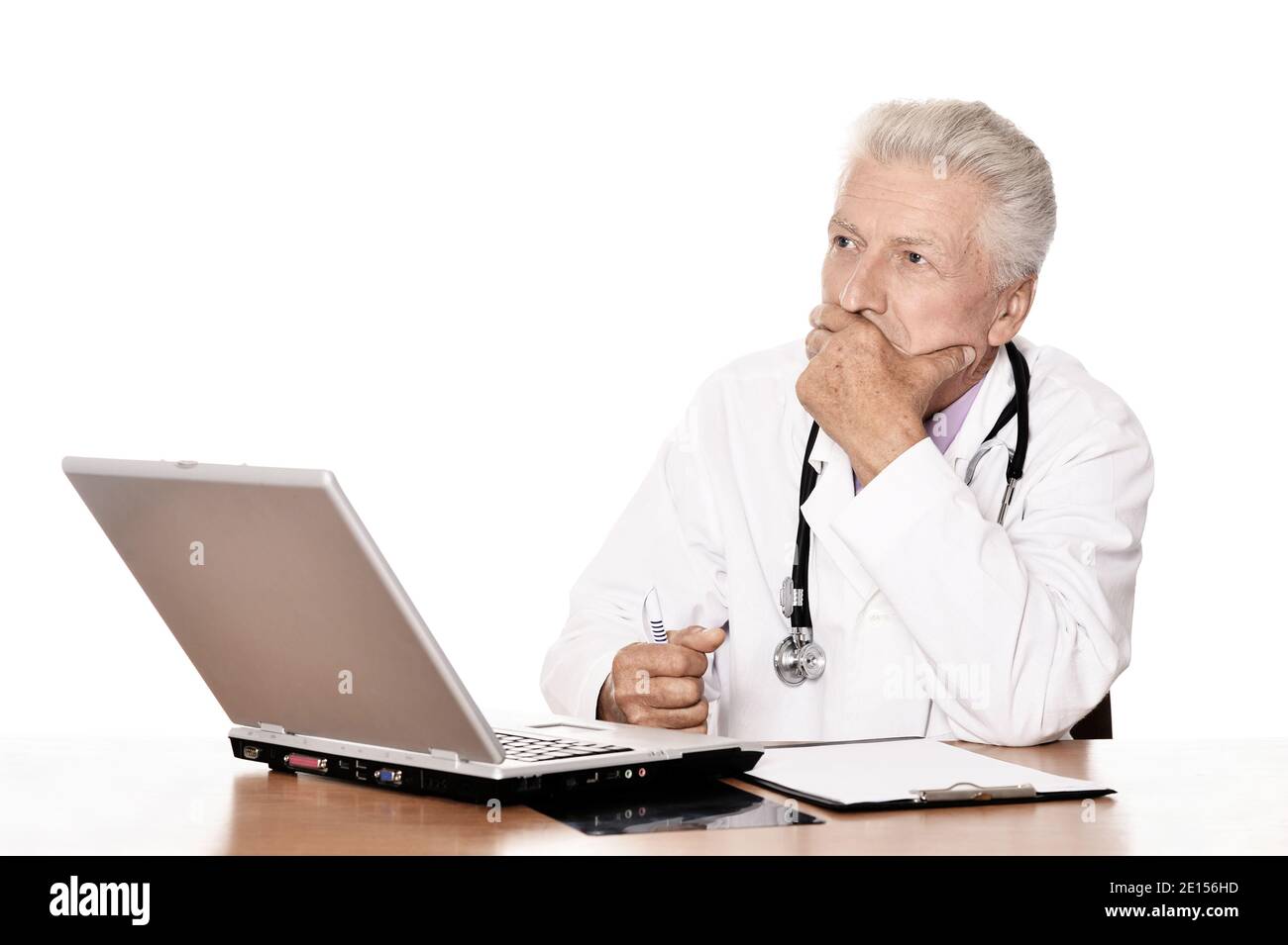 Elderly doctor with a laptop on white background Stock Photo - Alamy
