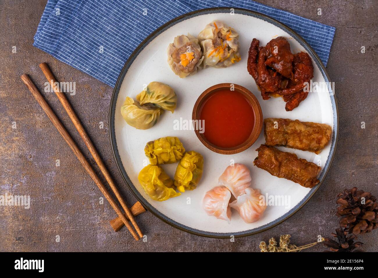 various variants of dim sum in ceramic plates and wooden chopsticks ...
