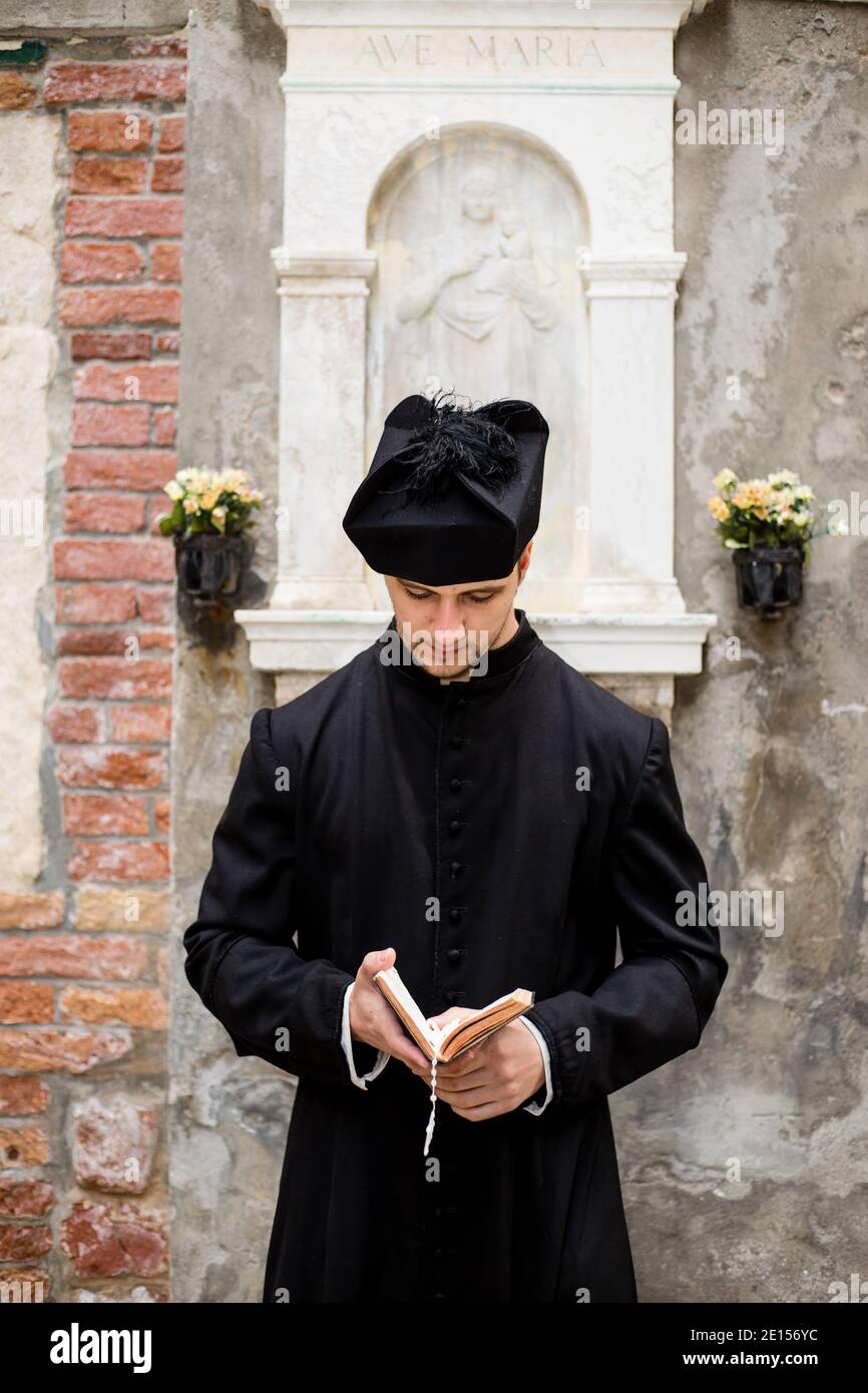 young priest in venice with church Stock Photo - Alamy