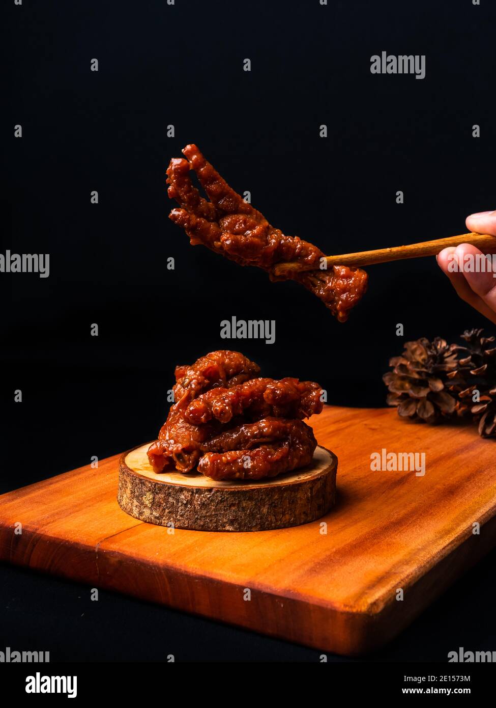 Phoenix claw dim sum on a wooden plate in a dark background. take the ...
