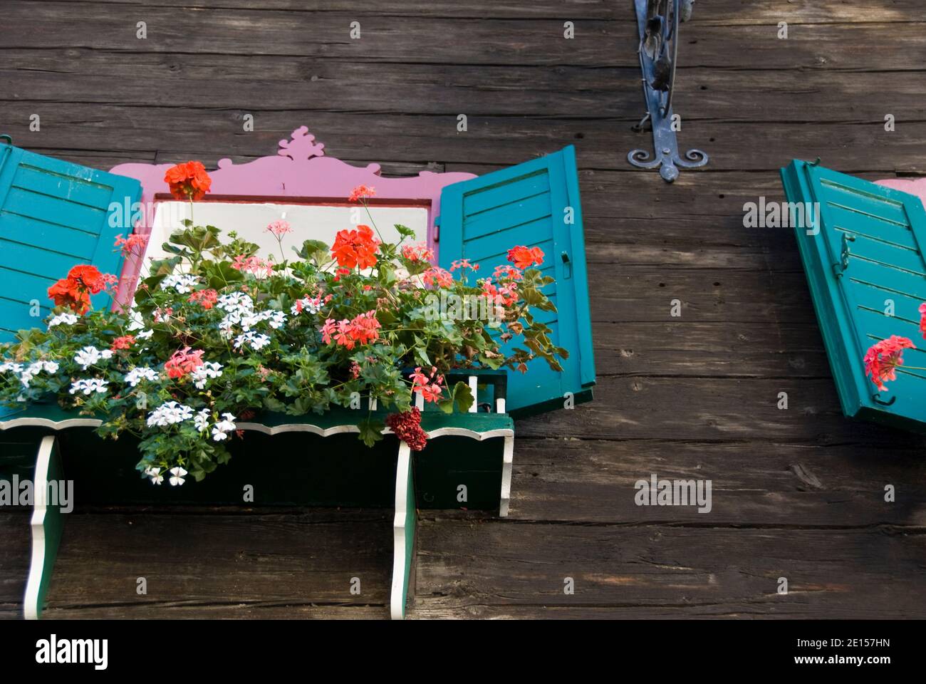Flowers in a window box decorates a traditional wooden home in Zell am ...