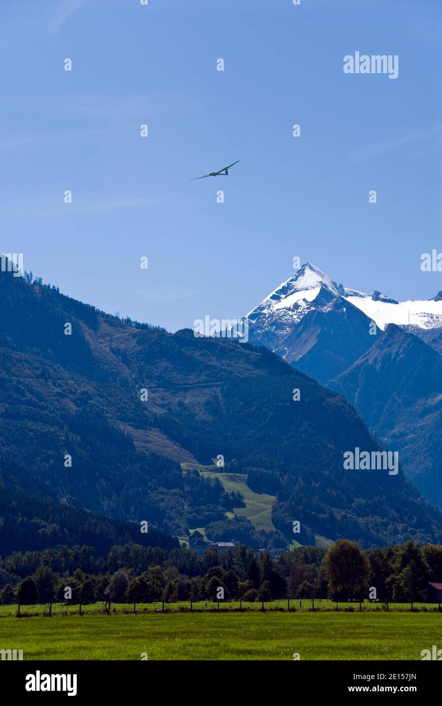 A glider (sailplane) flies over the airport at Zell am See, a popular ...