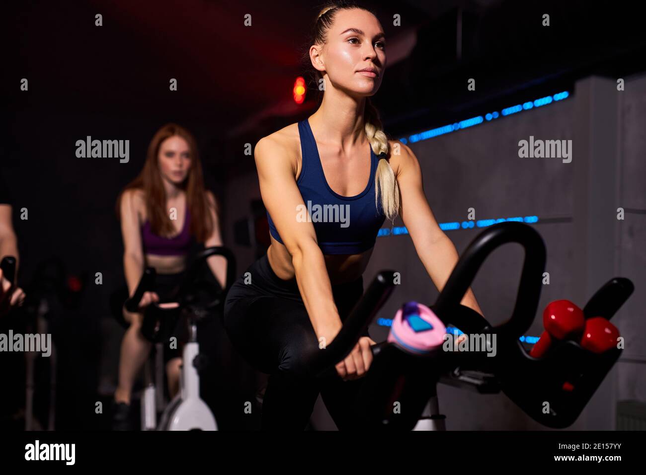 fit women at the gym riding on spinning bike in modern gym. healthy ...