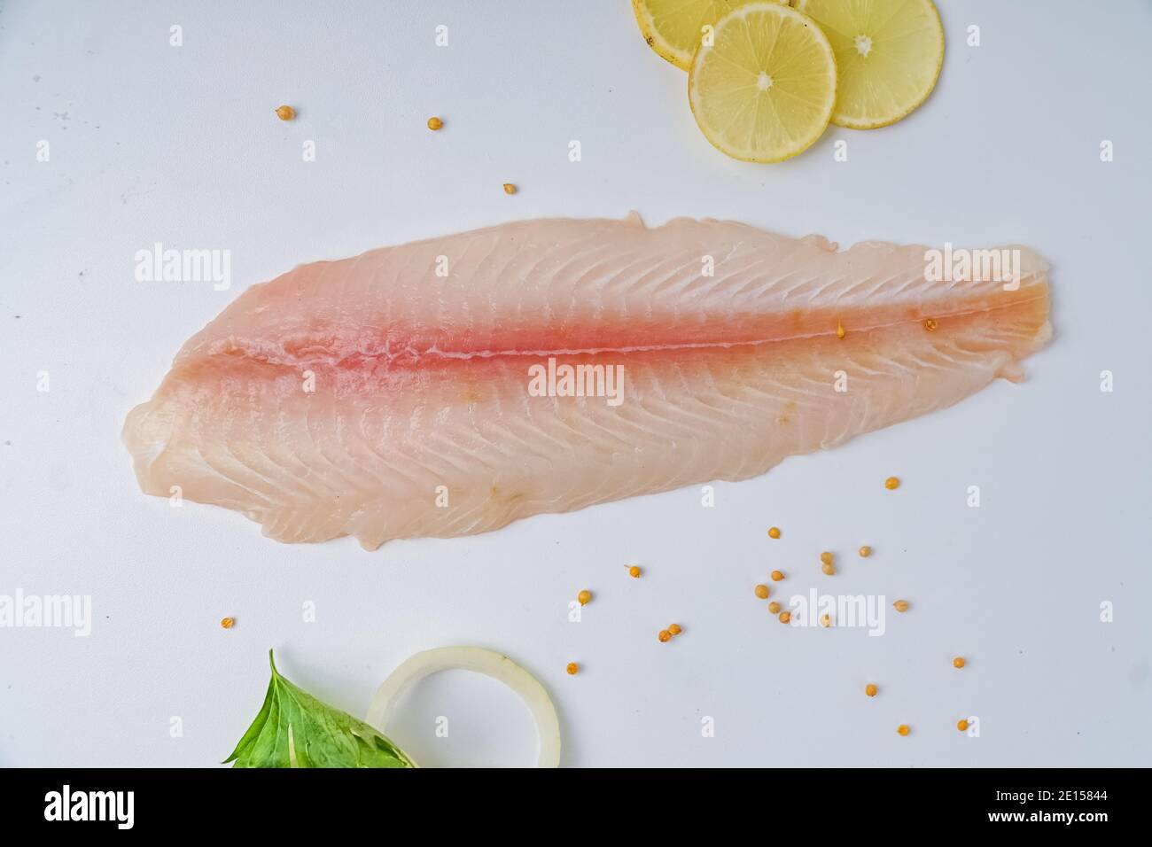 fresh fillet dory on a white background Stock Photo - Alamy