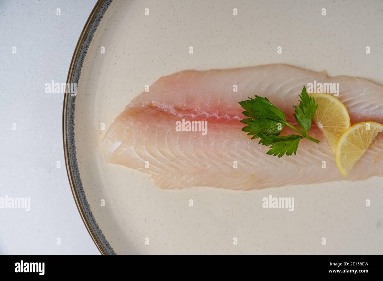 fresh fillet dory on a ceramic plate Stock Photo - Alamy