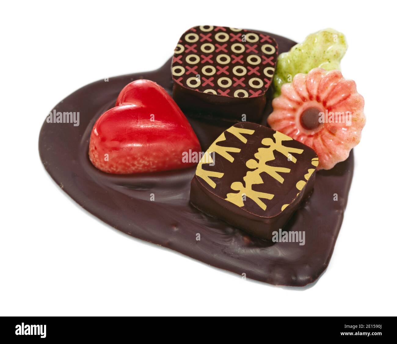 A piece of chocolate decorated with mini chocolates photographed on a ...