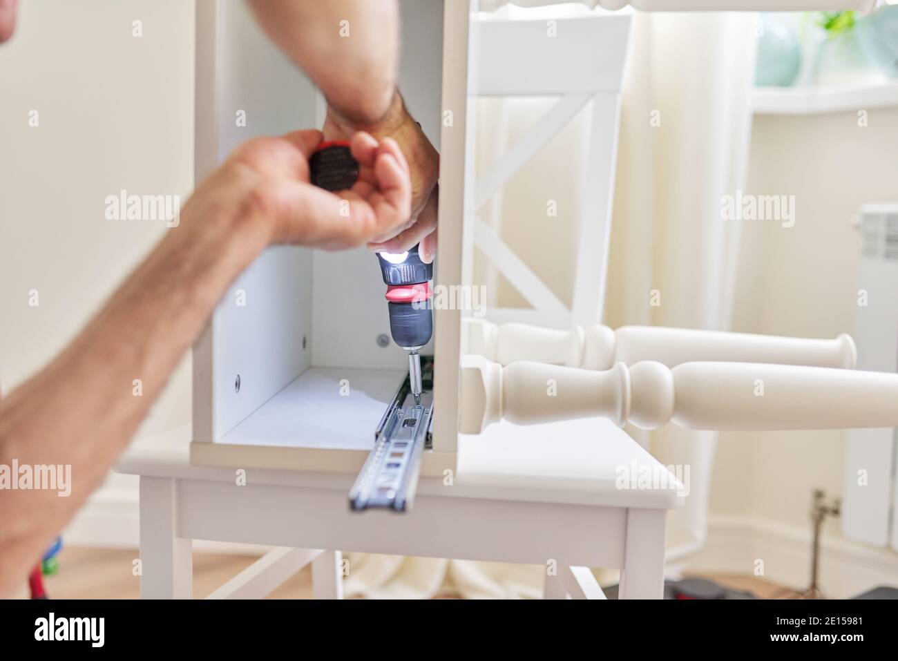 Close up detail of furniture and hands of carpenter worker with ...