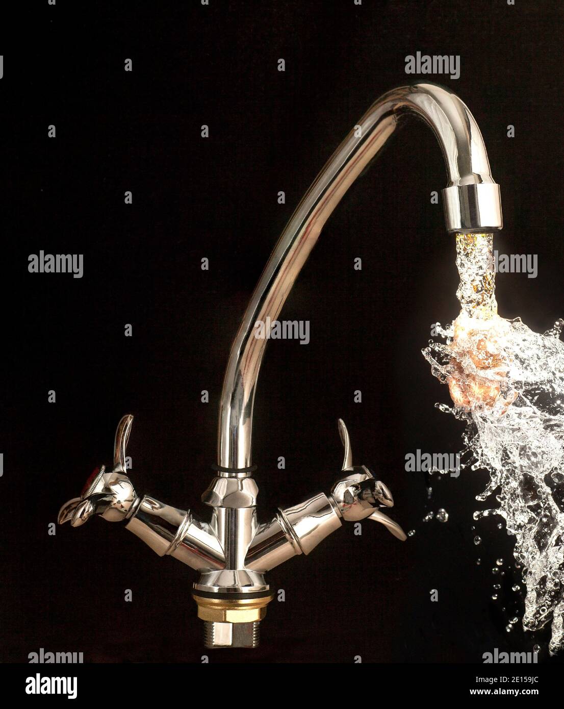 Modern kitchen faucet with water splash isolated on black background ...