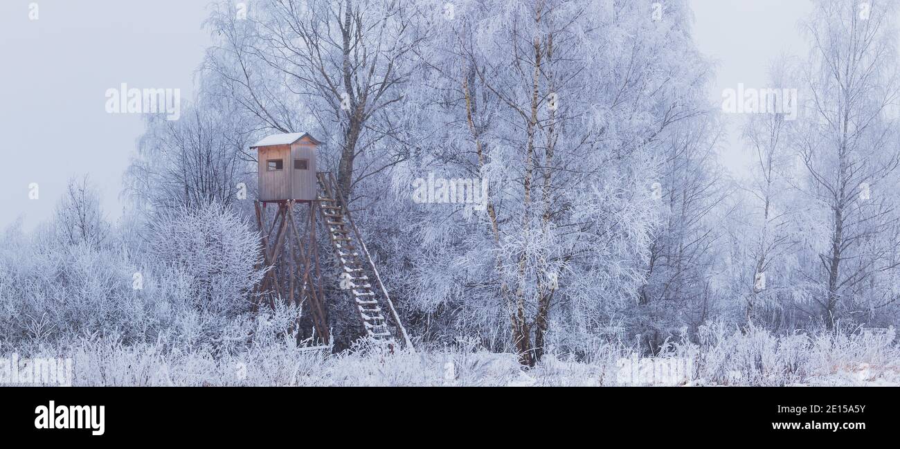 winter landscape with snow, hunting blind near the forest and meadow ...