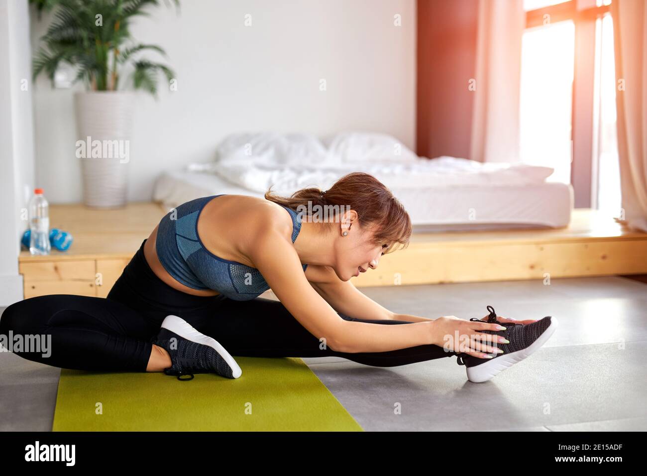 Asian female stretching legs on hi-res stock photography and images - Alamy